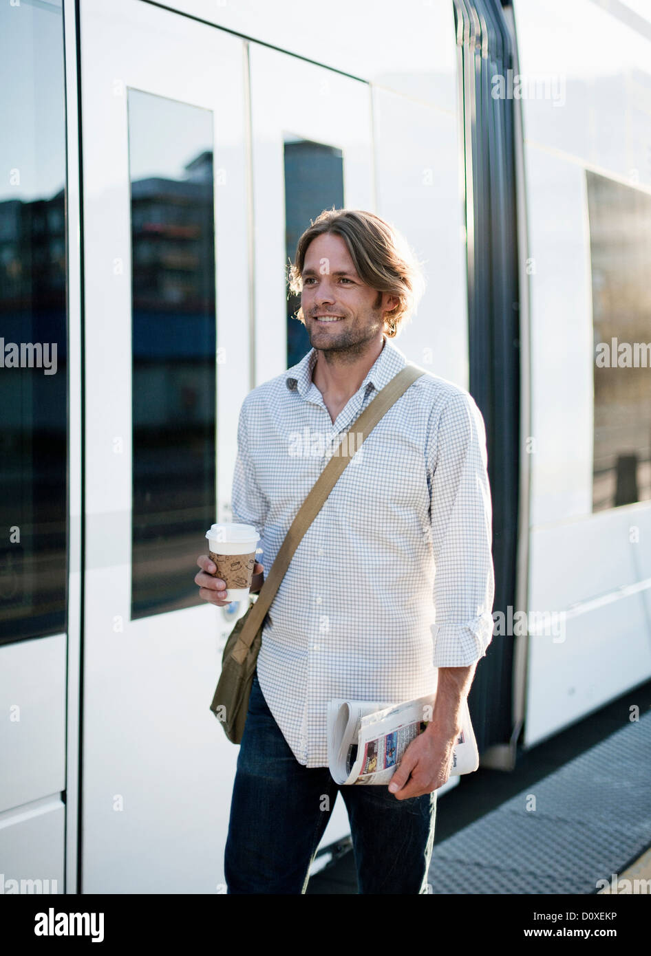 Male commuter at train station Stock Photo - Alamy