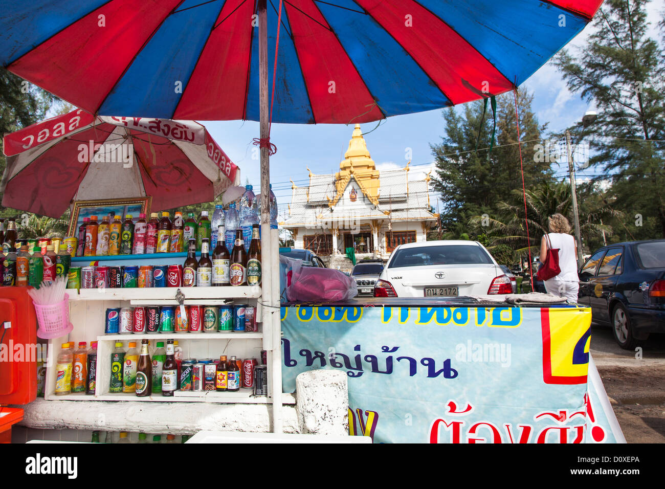 Beach-side stall at Surin Beach, Phuket, Thailand with Wat Surin in the ...