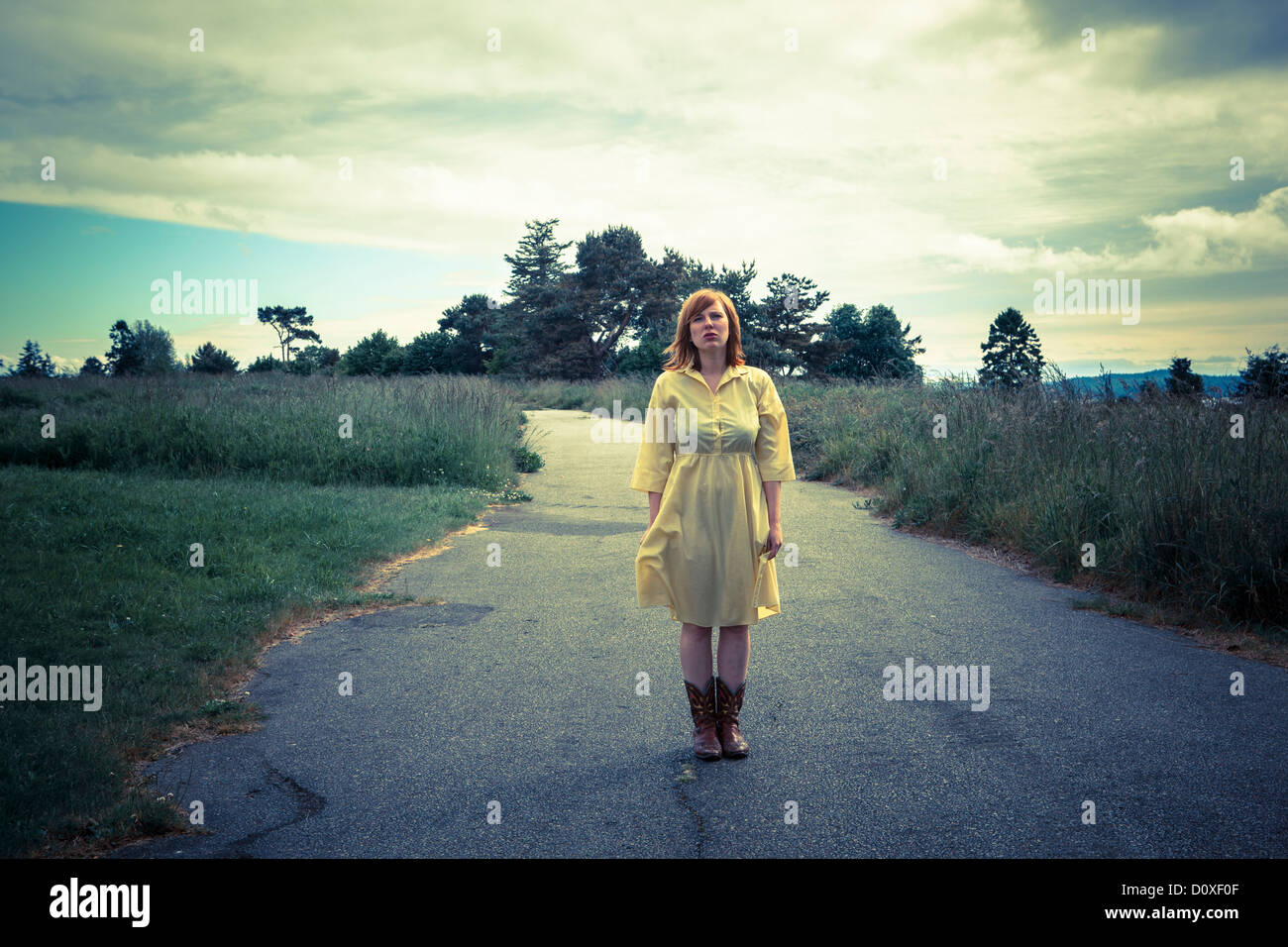 Young woman standing on rural path Stock Photo - Alamy