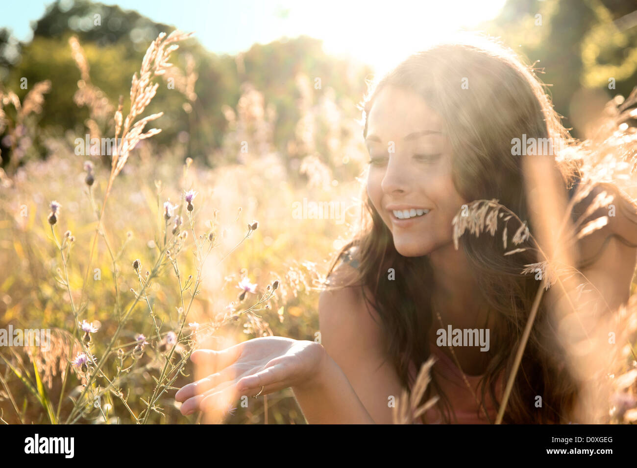 Teenage girl lying in field, close up Stock Photo - Alamy