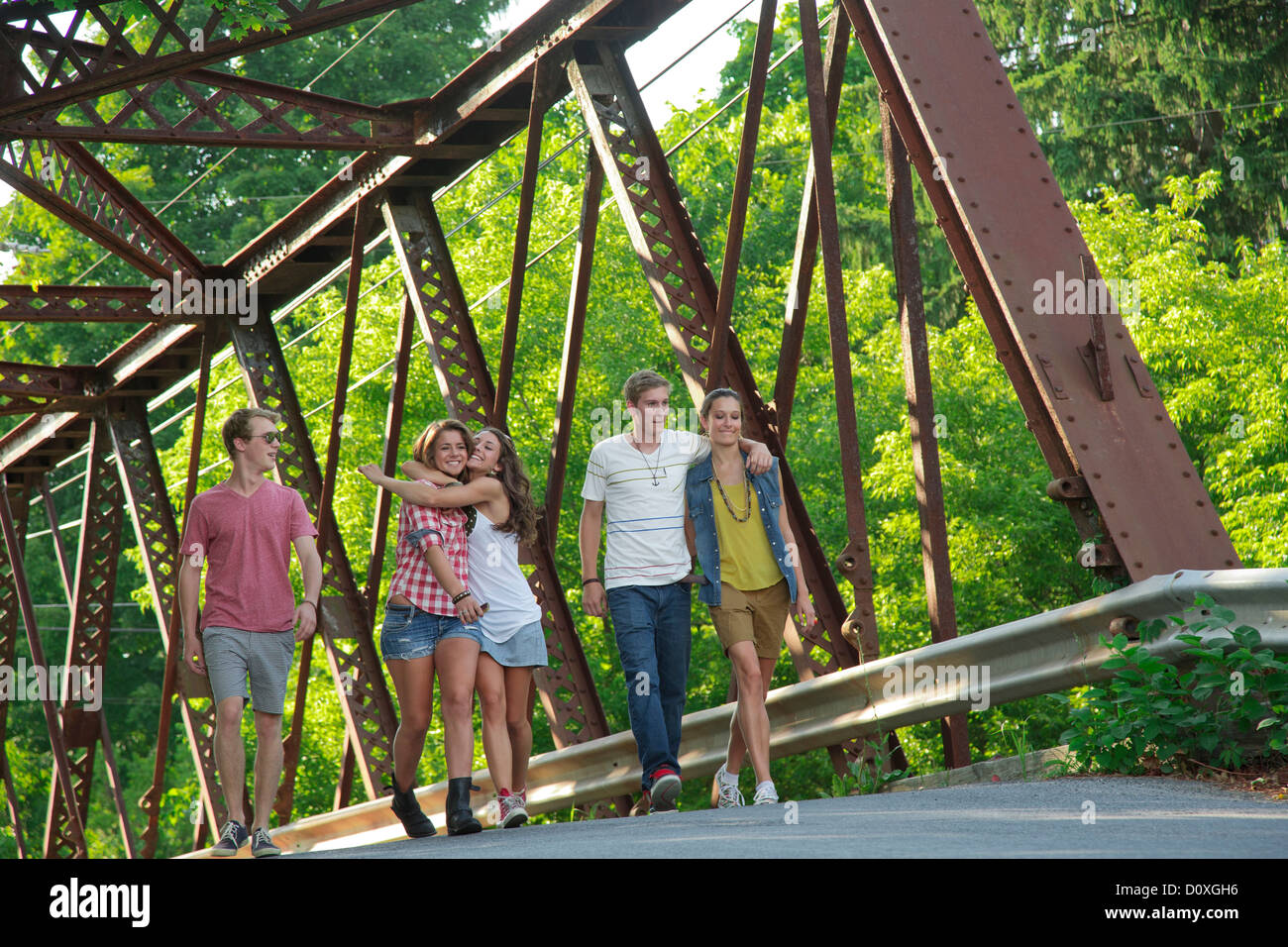 Group of friends walking on bridge Stock Photo - Alamy