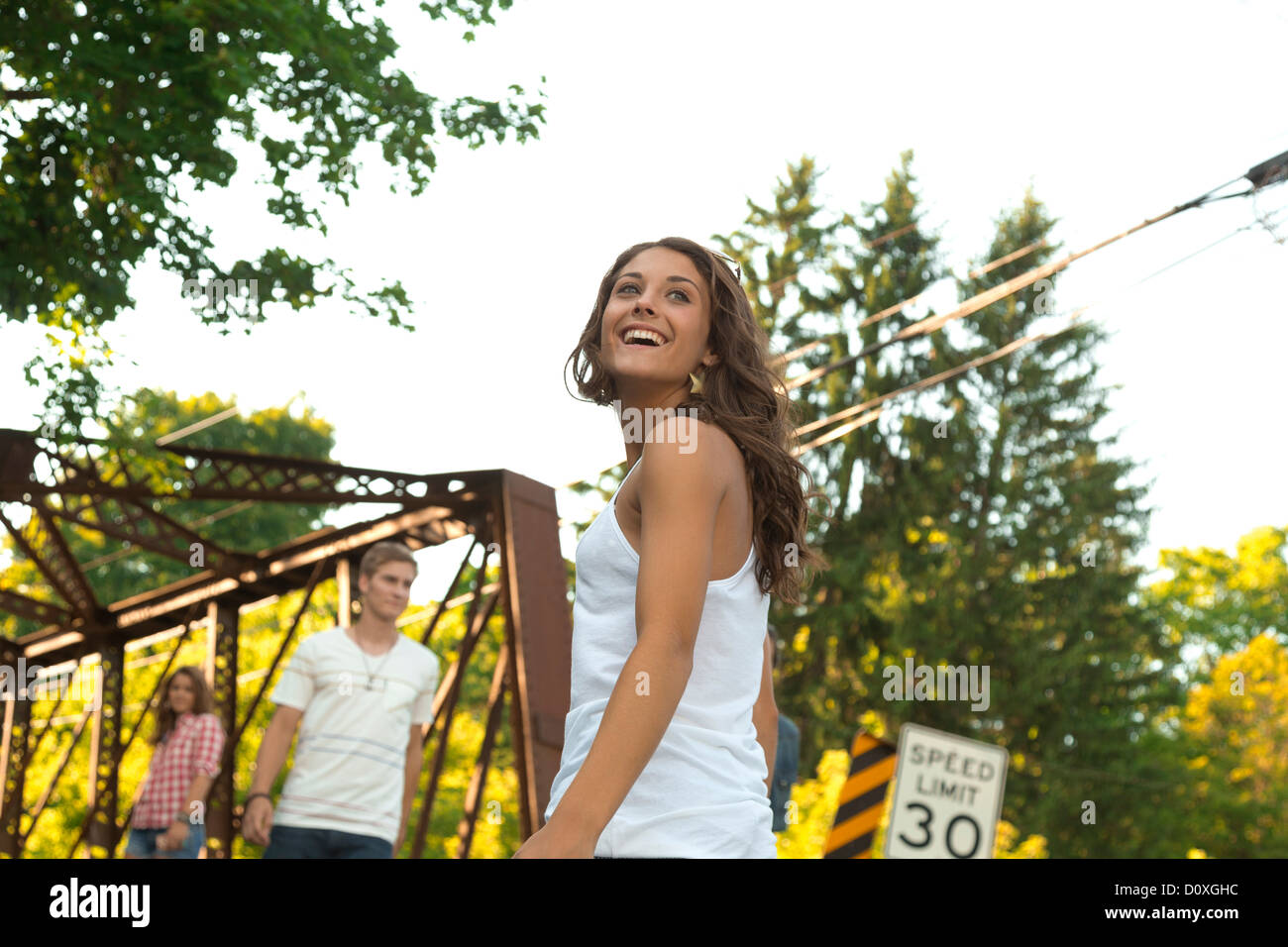 Teenage girl on bridge with friends Stock Photo - Alamy