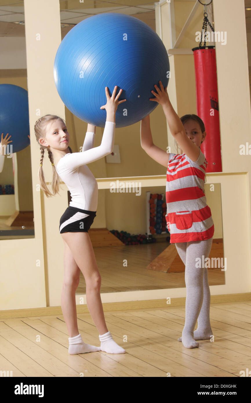 Girls raising ball over head Stock Photo - Alamy