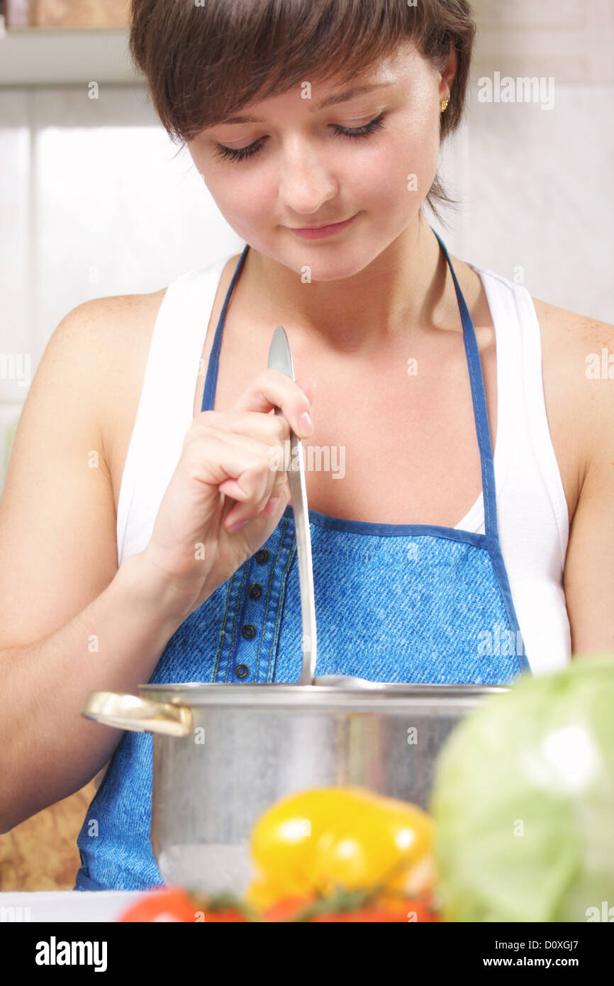 Woman cooking pan and vegetables blue hi-res stock photography and ...
