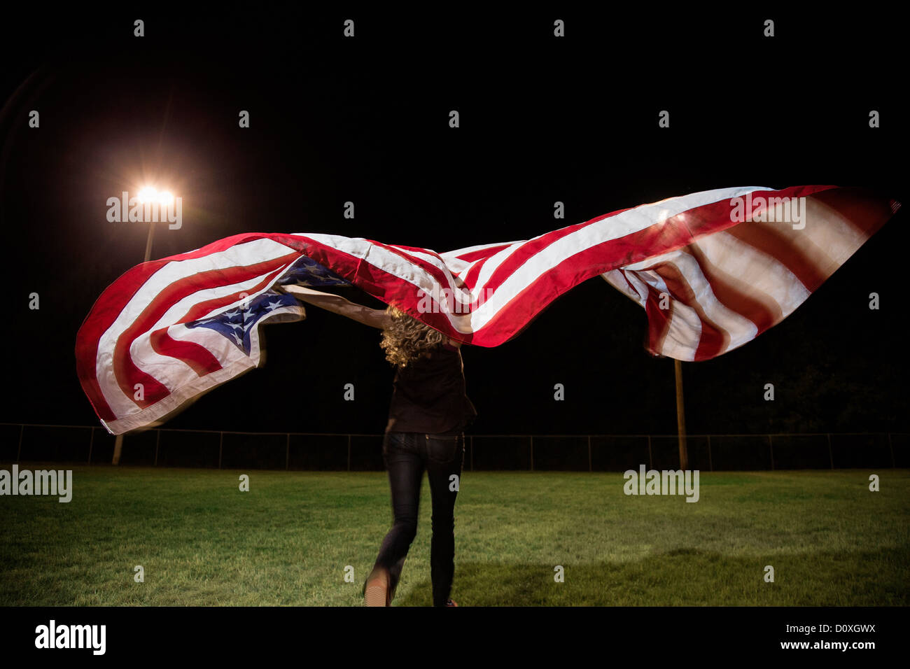 Girl holding american flag at night Stock Photo - Alamy