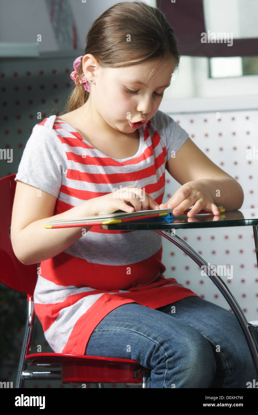 Girl reading book aloud Stock Photo - Alamy