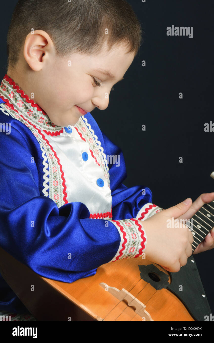 Little boy playing balalaika Stock Photo - Alamy