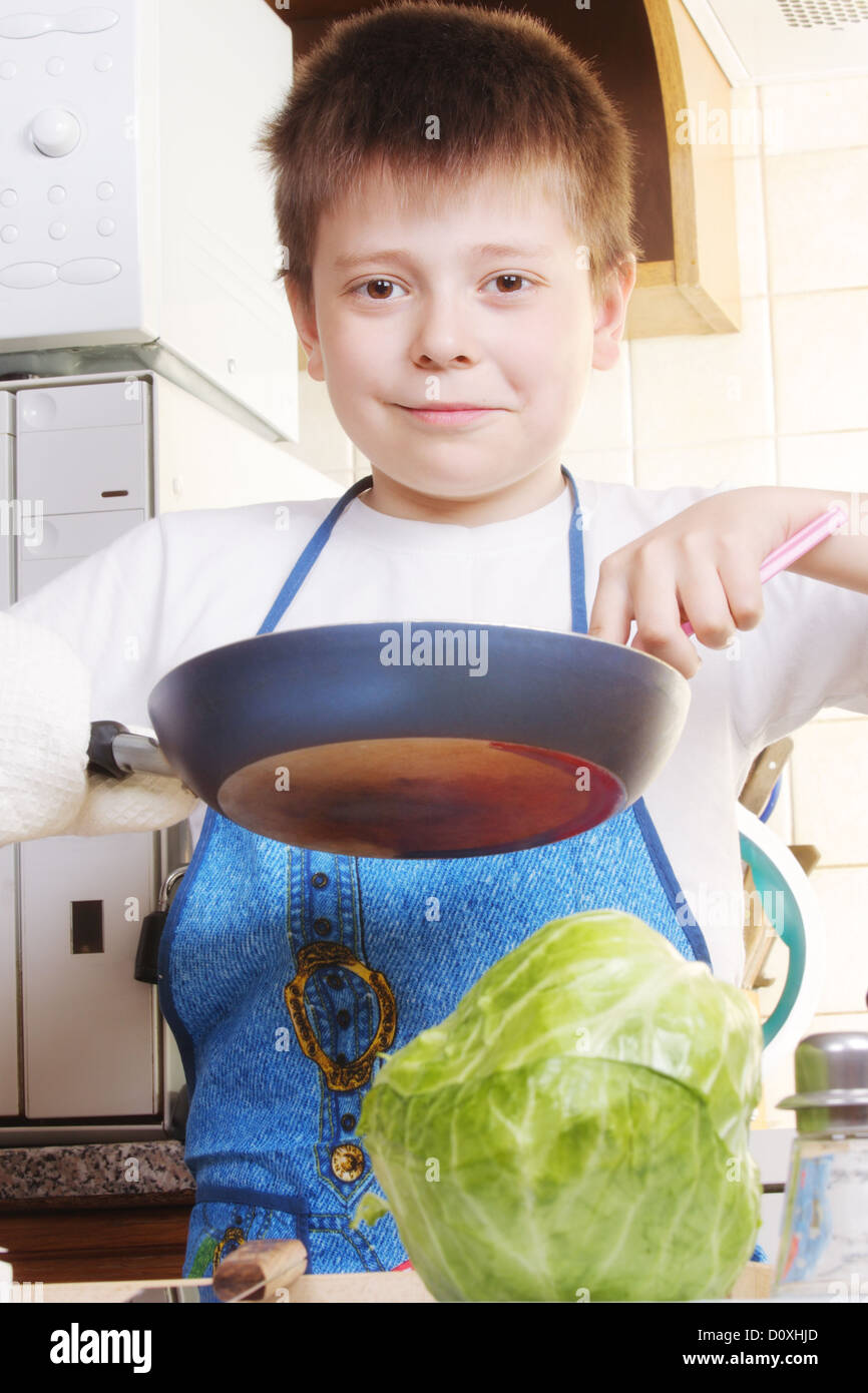 Smiling boy with frying-pan Stock Photo - Alamy