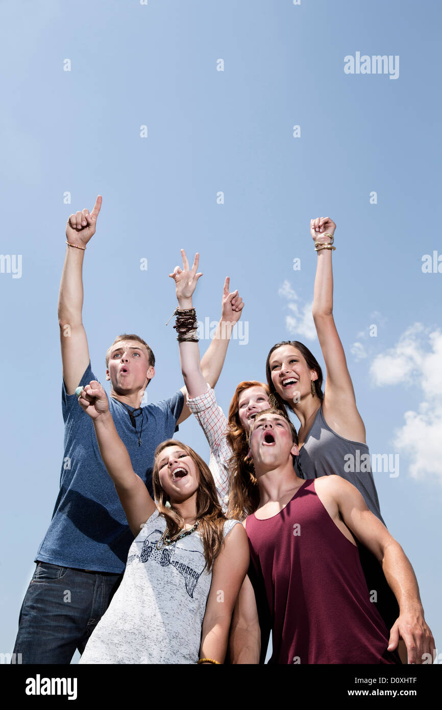 Five friends cheering, low angle Stock Photo - Alamy