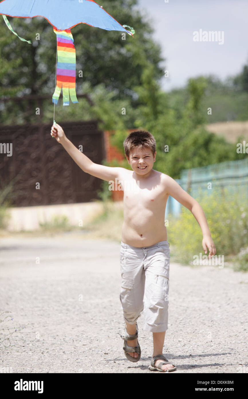 Boy running with kite Stock Photo - Alamy
