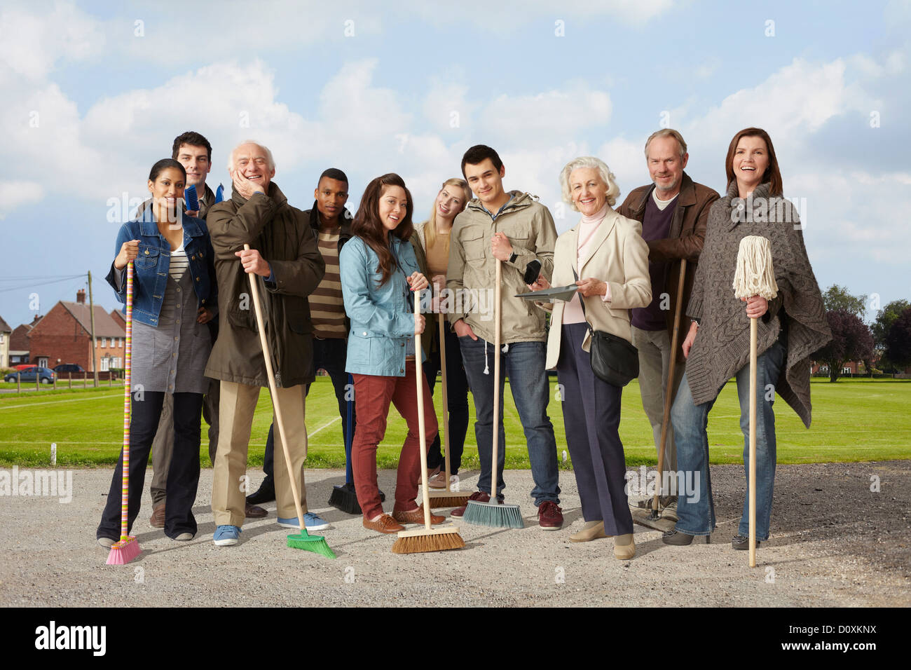 Group of people standing with brooms and mop Stock Photo - Alamy