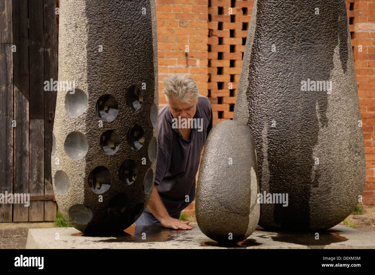 Sculptor Stephen Cox 'anoints' his sculpture "Holy Family" at his ...