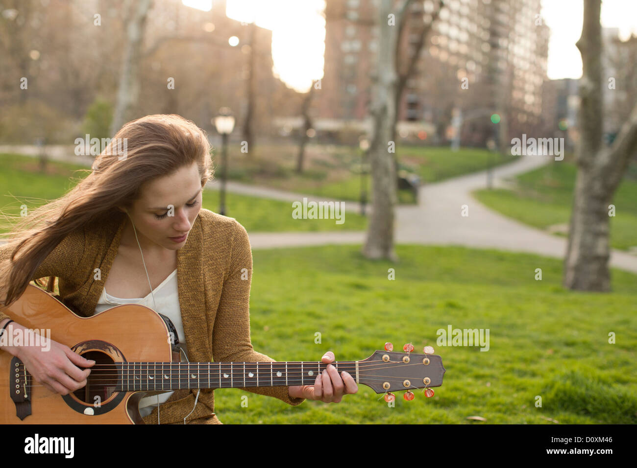 Young woman playing guitar in the park Stock Photo - Alamy
