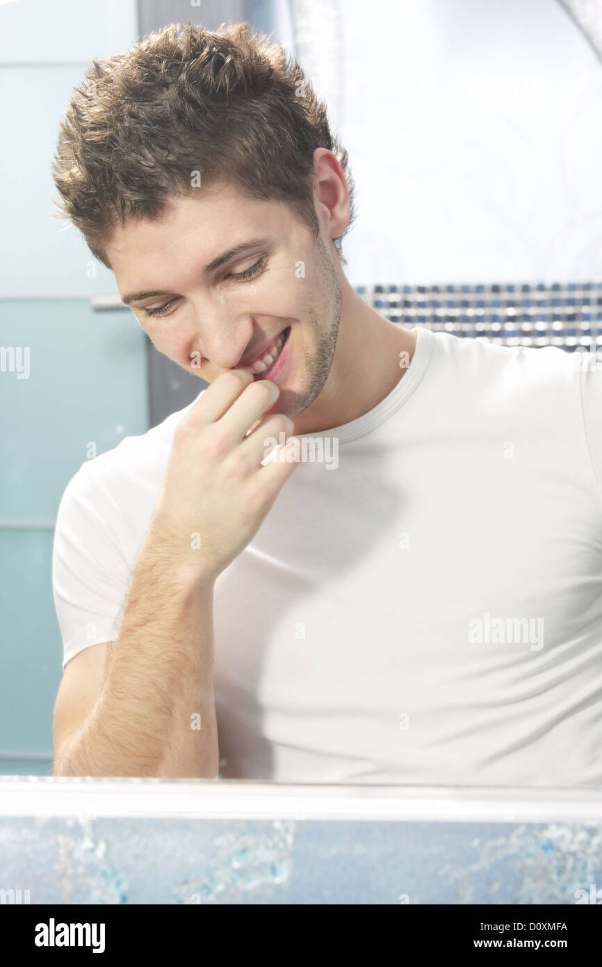 Confused guy at mirror Stock Photo - Alamy