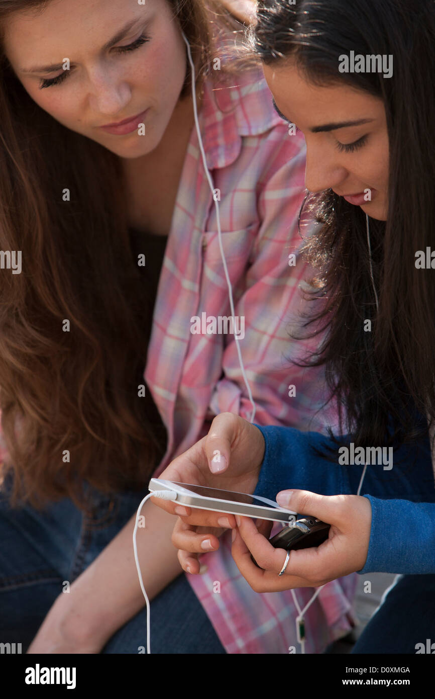 Young women sharing music Stock Photo - Alamy