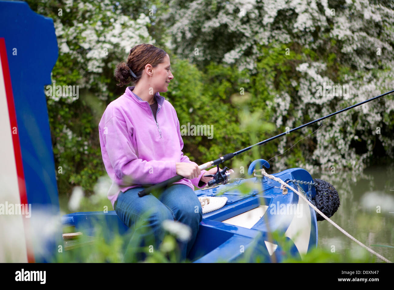 girl fishing on a narrowboat Stock Photo - Alamy