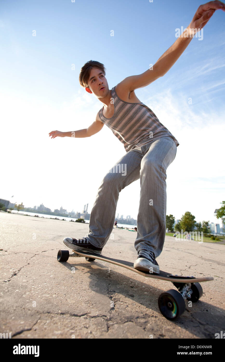 Young man skateboarding Stock Photo - Alamy