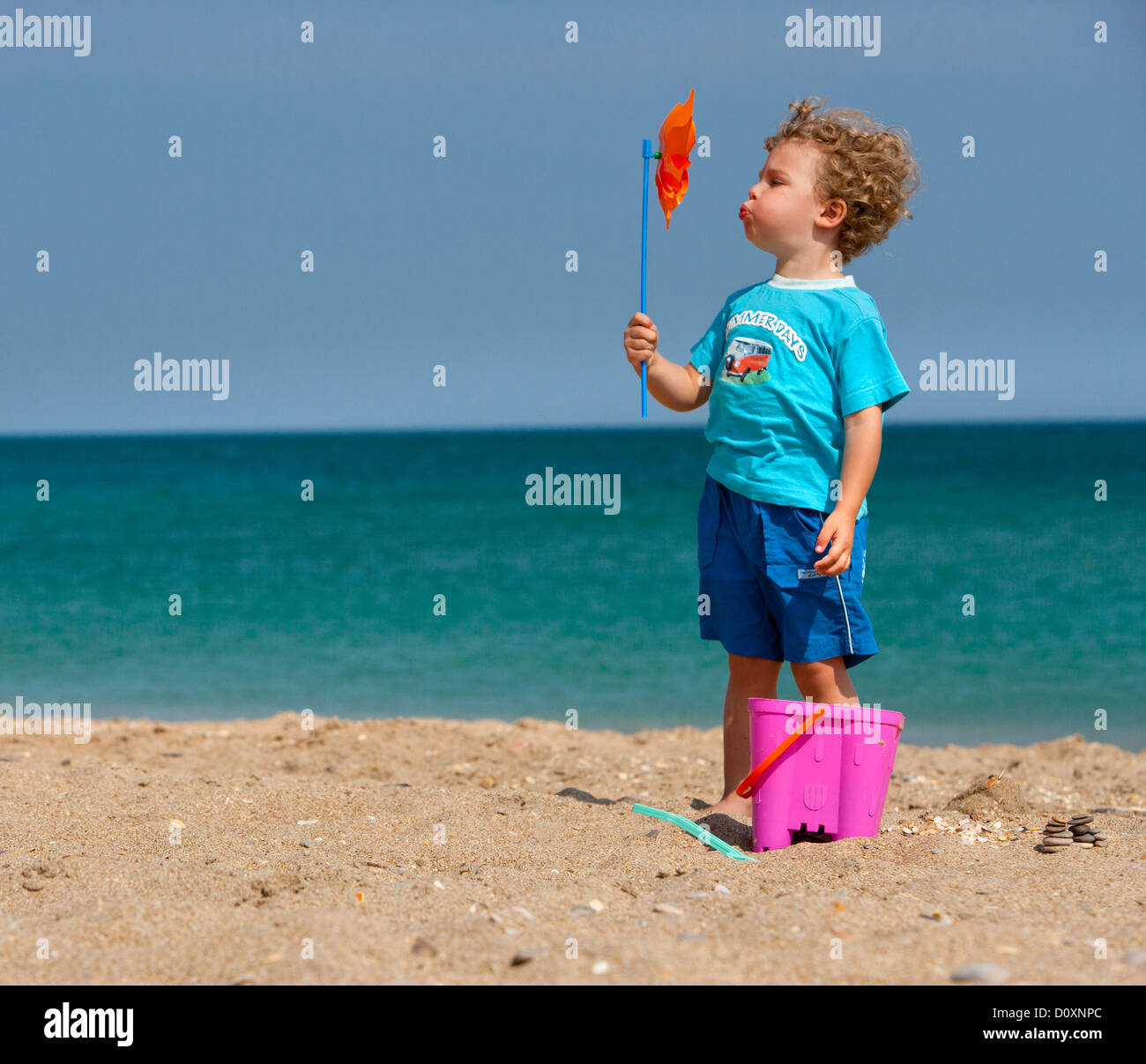 boy with windmill on the beach Stock Photo - Alamy