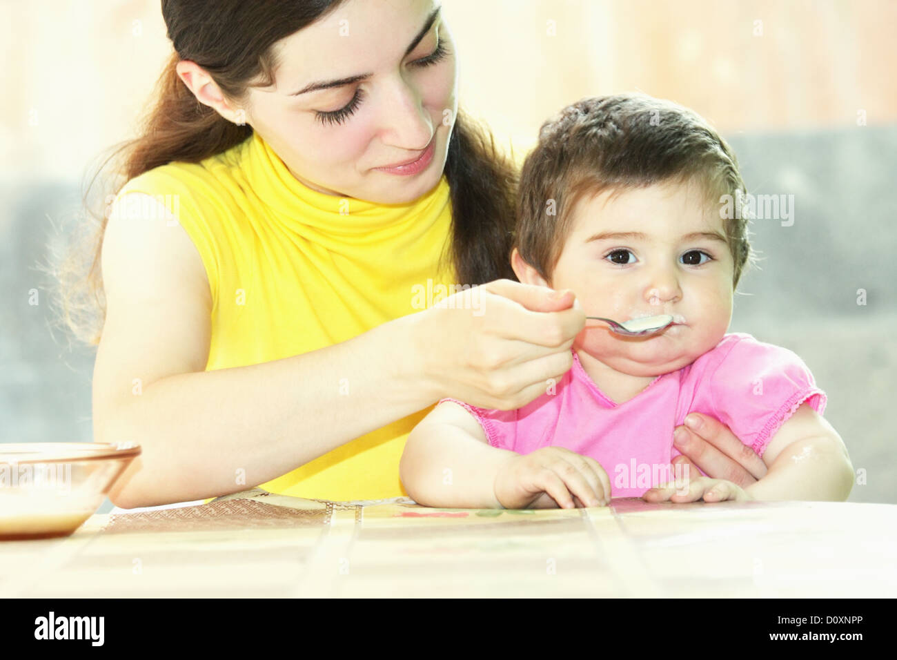 Mother feeding baby Stock Photo - Alamy