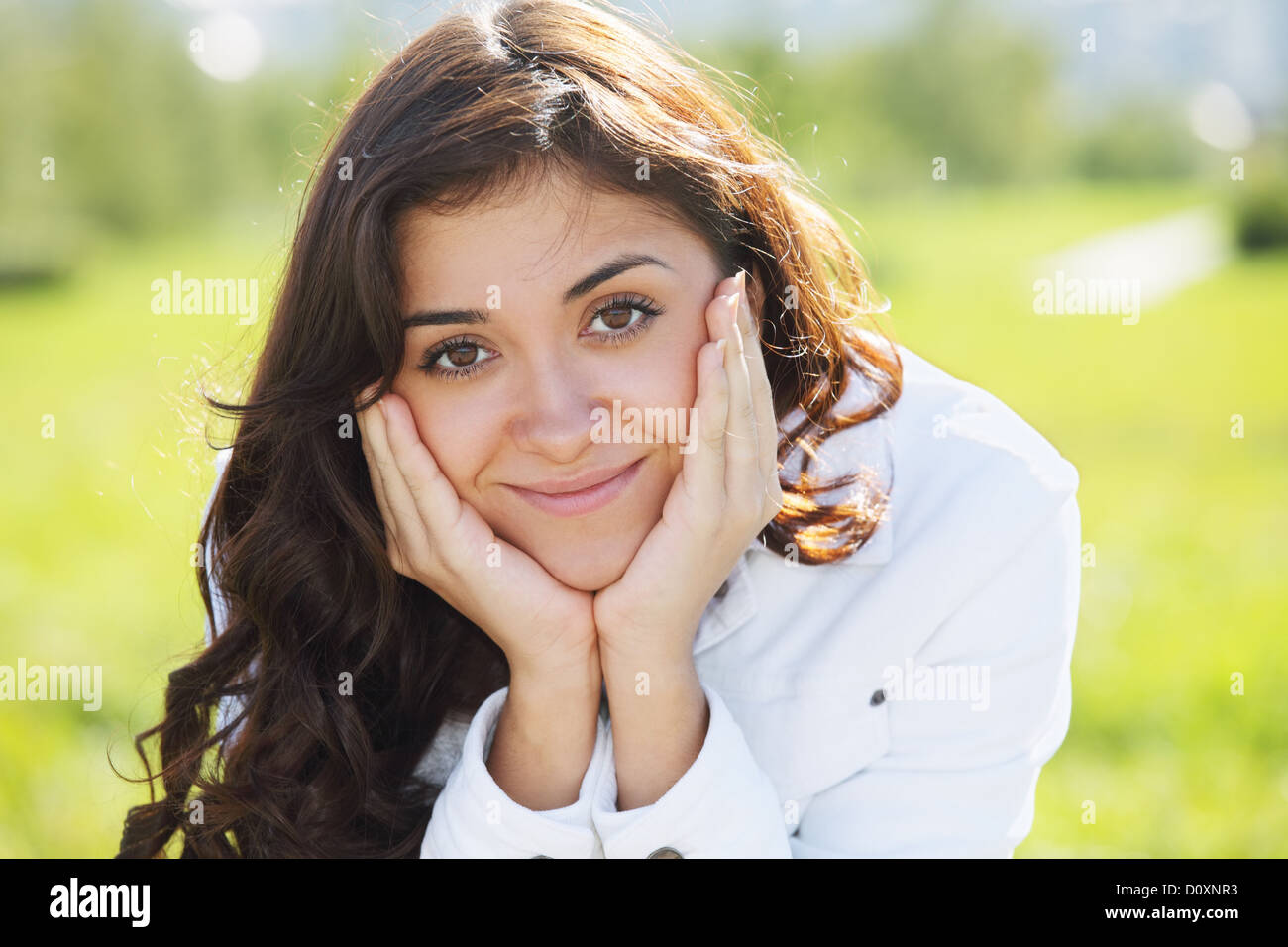 Young brunette leaning on hands Stock Photo - Alamy