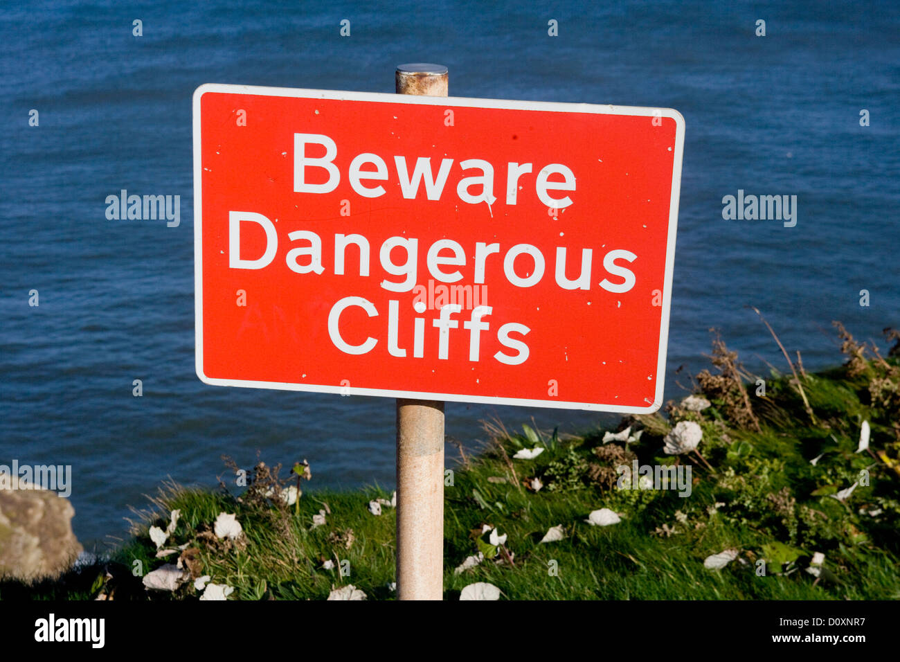 Warning sign post for dangerous cliffs, Filey Brigg, North Yorkshire ...