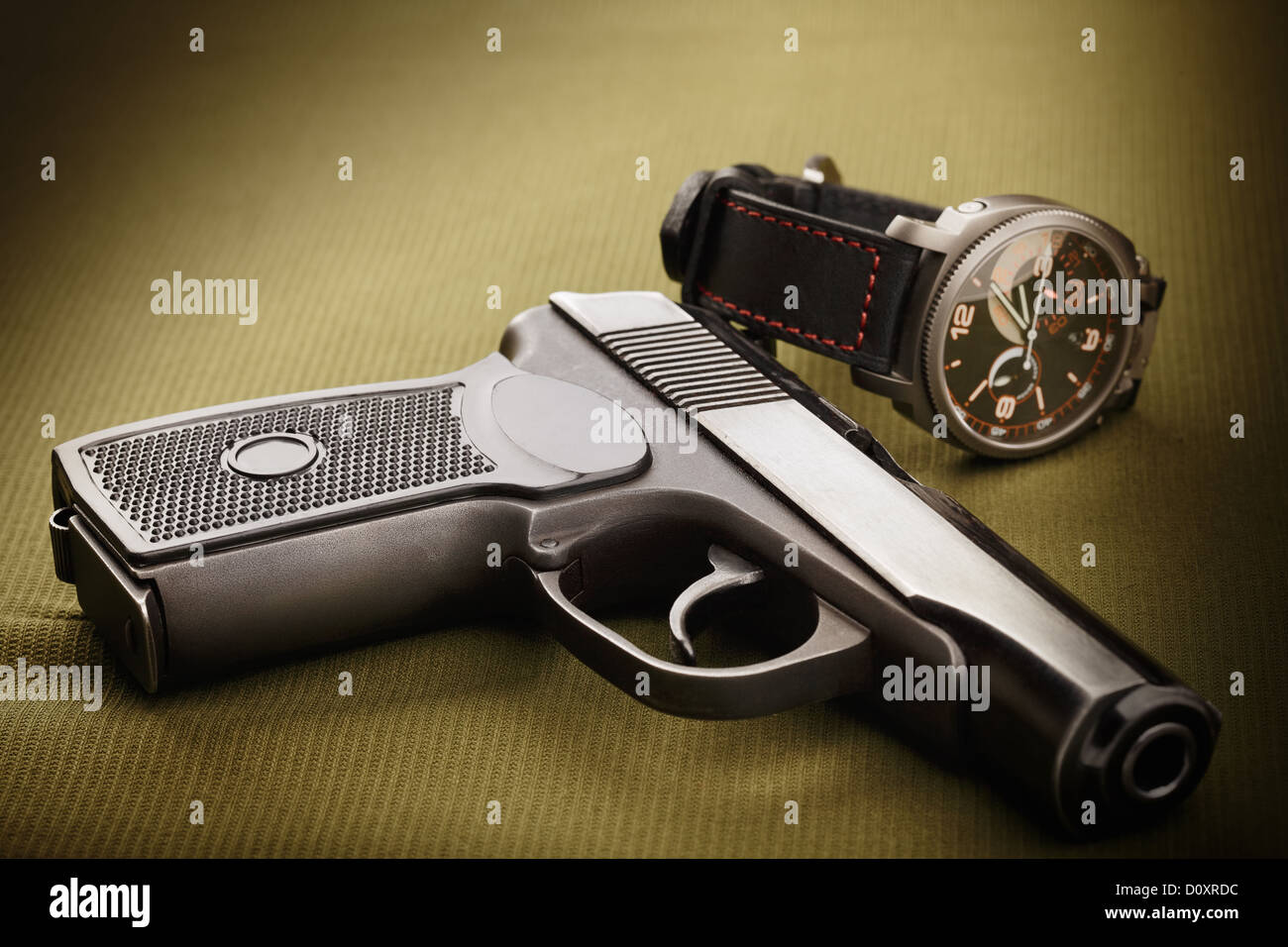 Gun and watch Stock Photo - Alamy