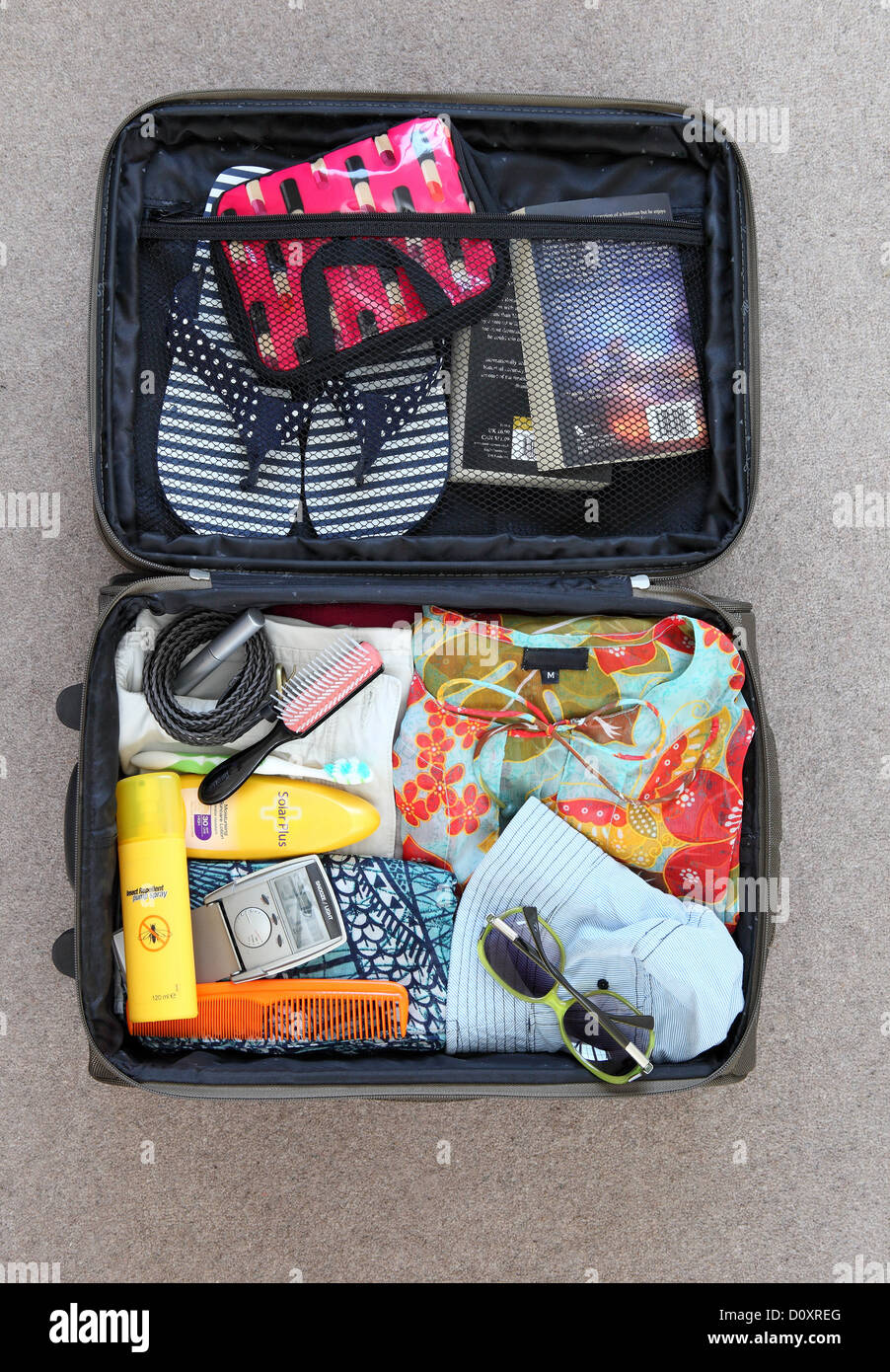 Suitcase packed for vacation Stock Photo - Alamy