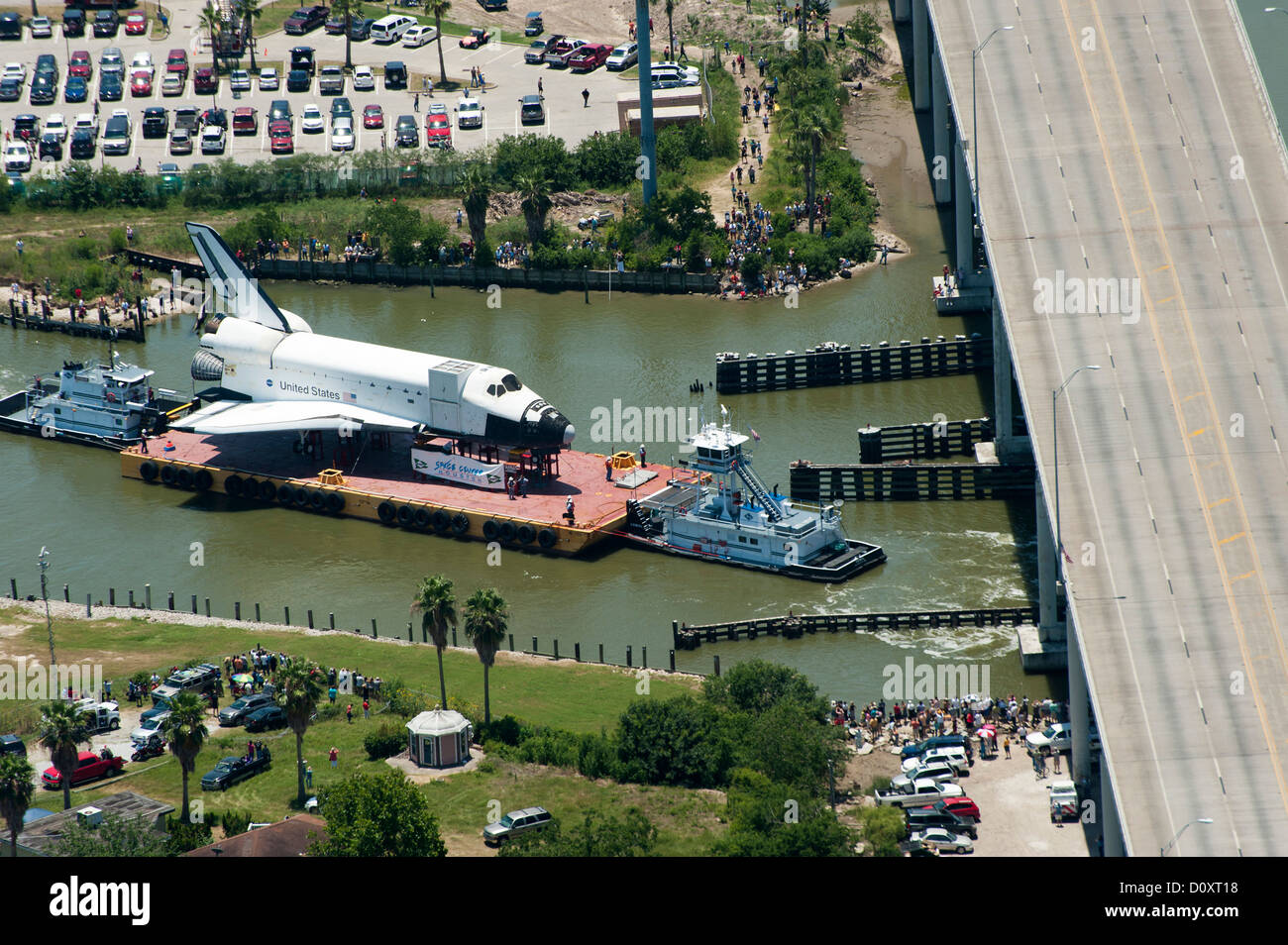 The NASA training shuttle is taken by barge safely through the tight ...