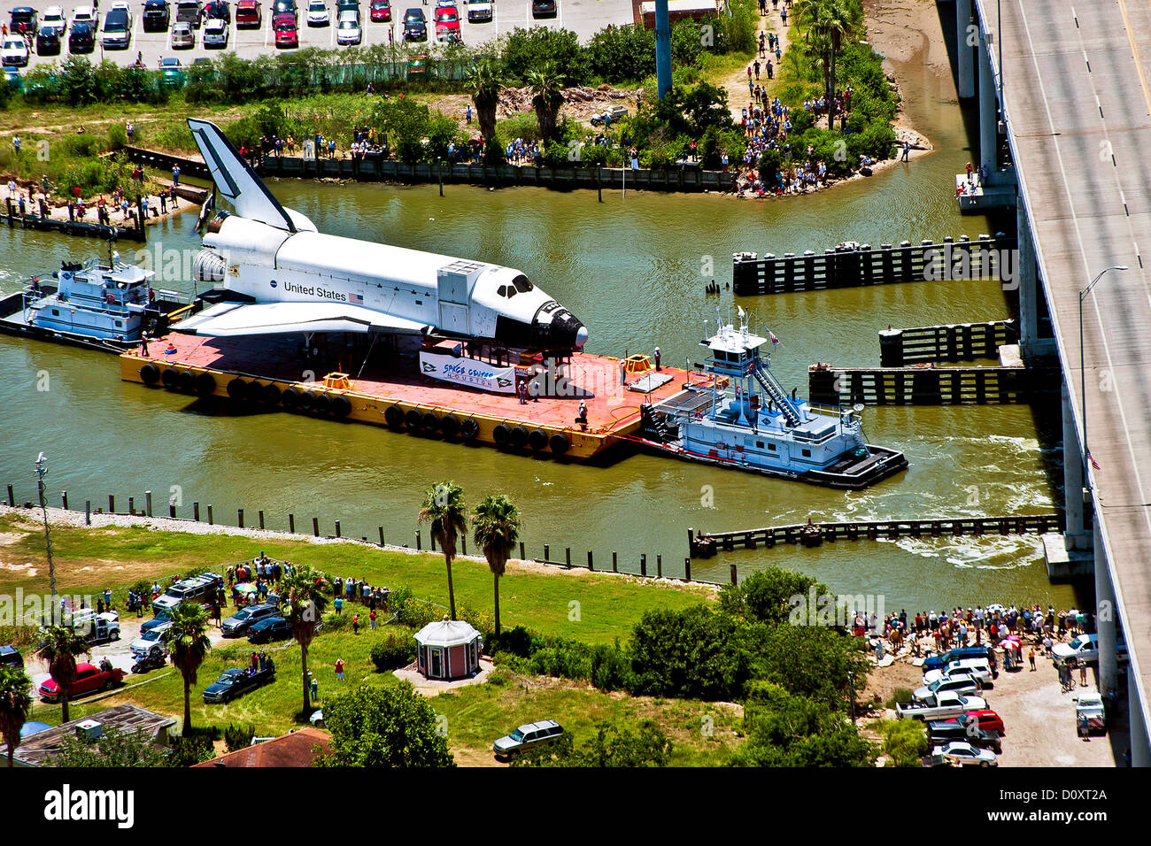 The NASA training shuttle is taken by barge safely through the tight ...