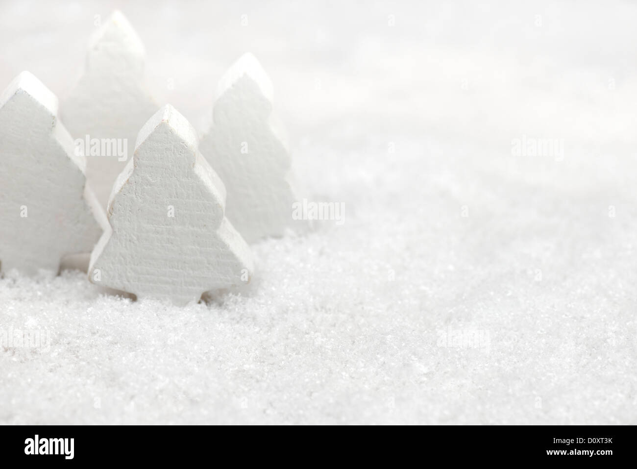 White Christmas tree deco in the snow Stock Photo - Alamy