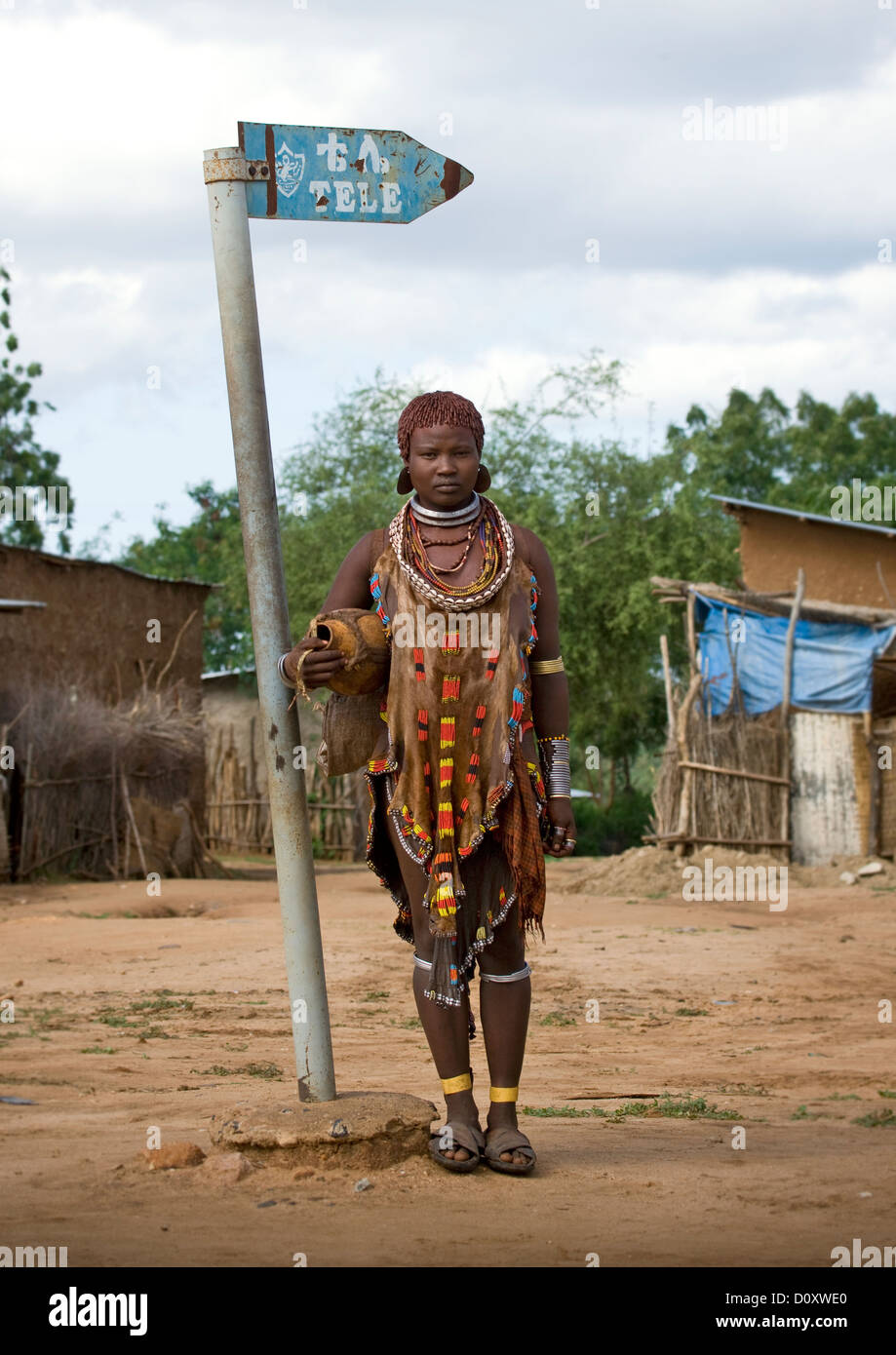 Hamar Tribe Woman With Traditional Clothes Posing Next To A Sign ...