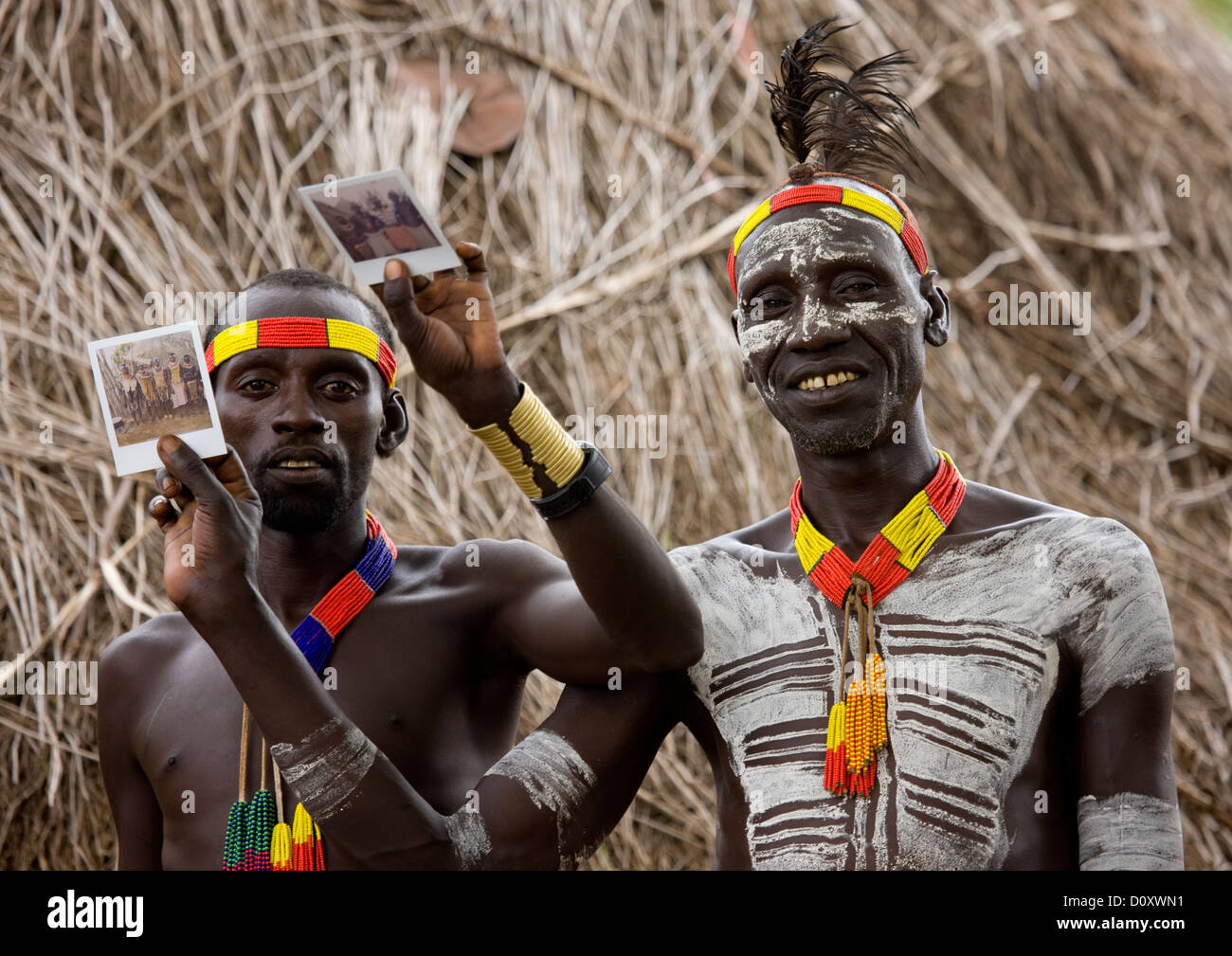 Karo Tribe Men With Body Paintings Showing Polaroids Of The Tribe ...