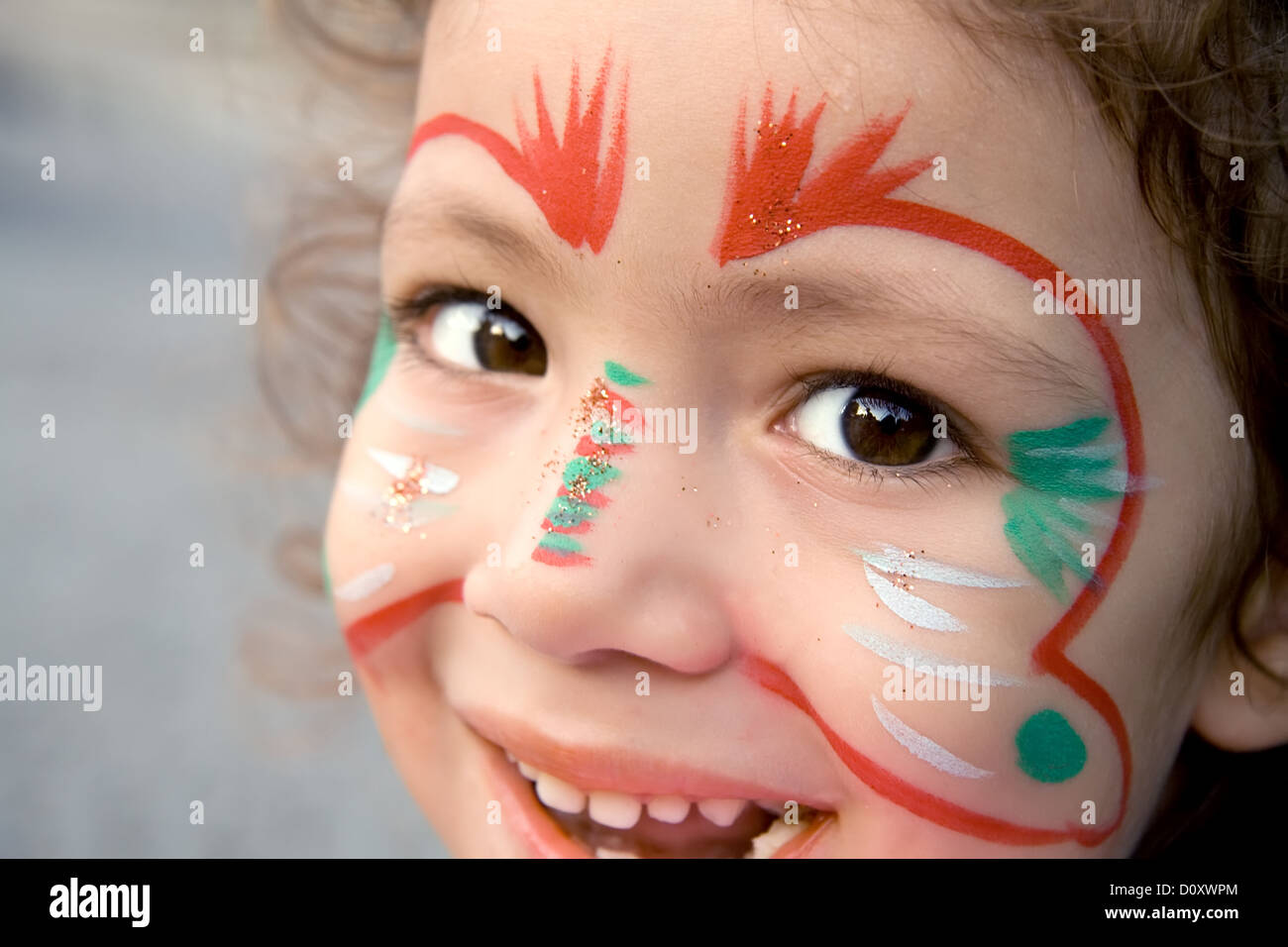 A close up of a Turkish little girl's face painted of a butterfly ...