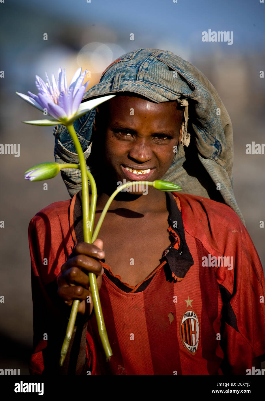 Portrait Of A Boy From Oromo Tribe Holding A Water Lily, Chamo Lake ...