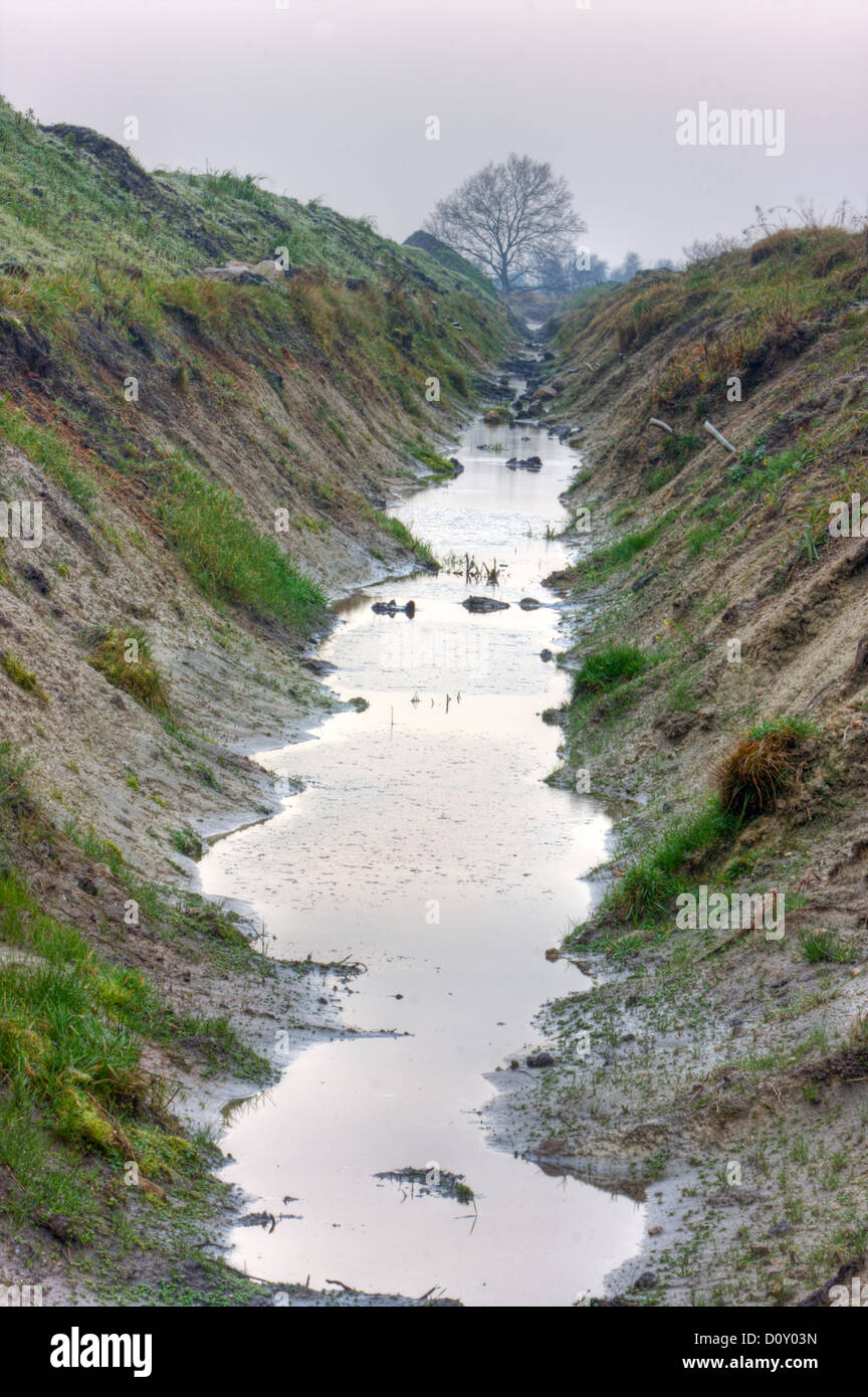 Digging a new ditch in farmland Stock Photo - Alamy
