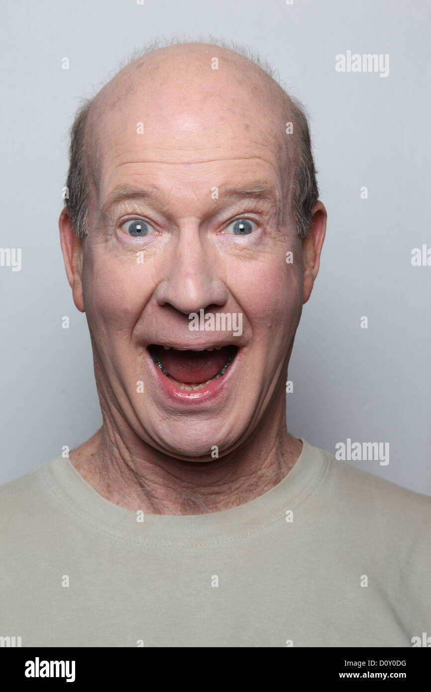 Man making funny face showing teeth Stock Photo - Alamy