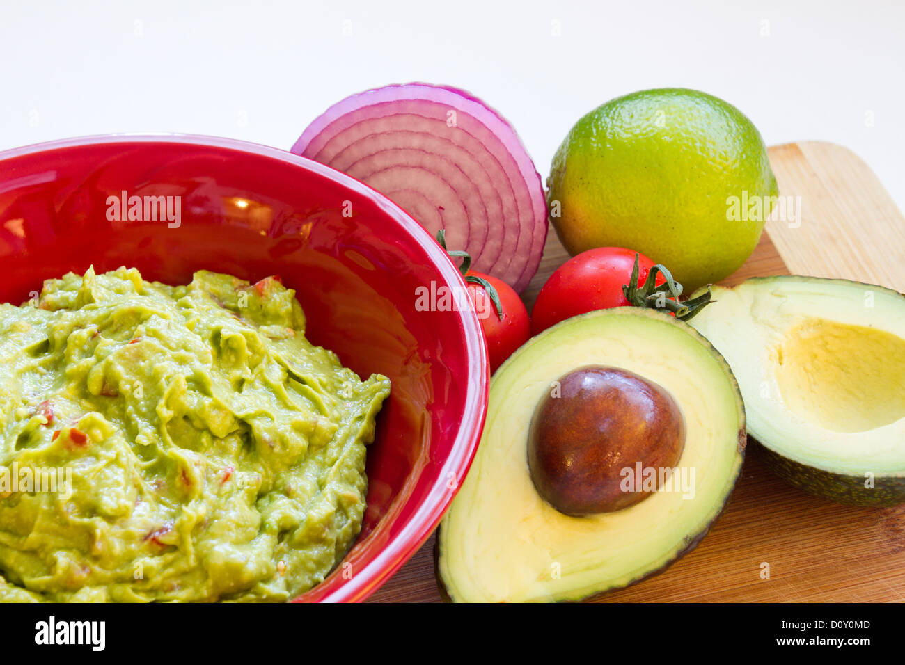 Avocado sliced, tomatoes, red onion, lime and guacamole closeup Stock ...