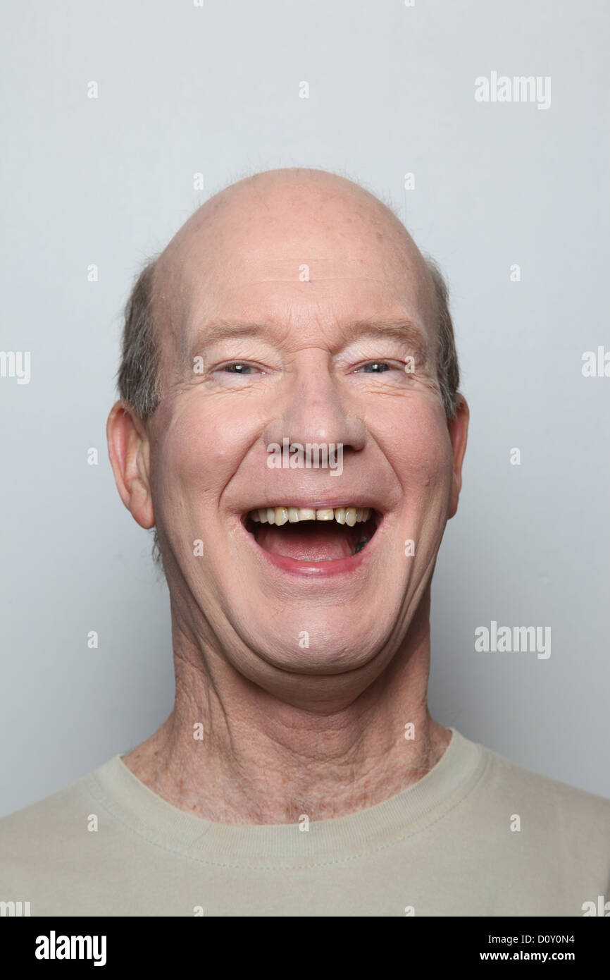 Man making funny face showing teeth Stock Photo - Alamy