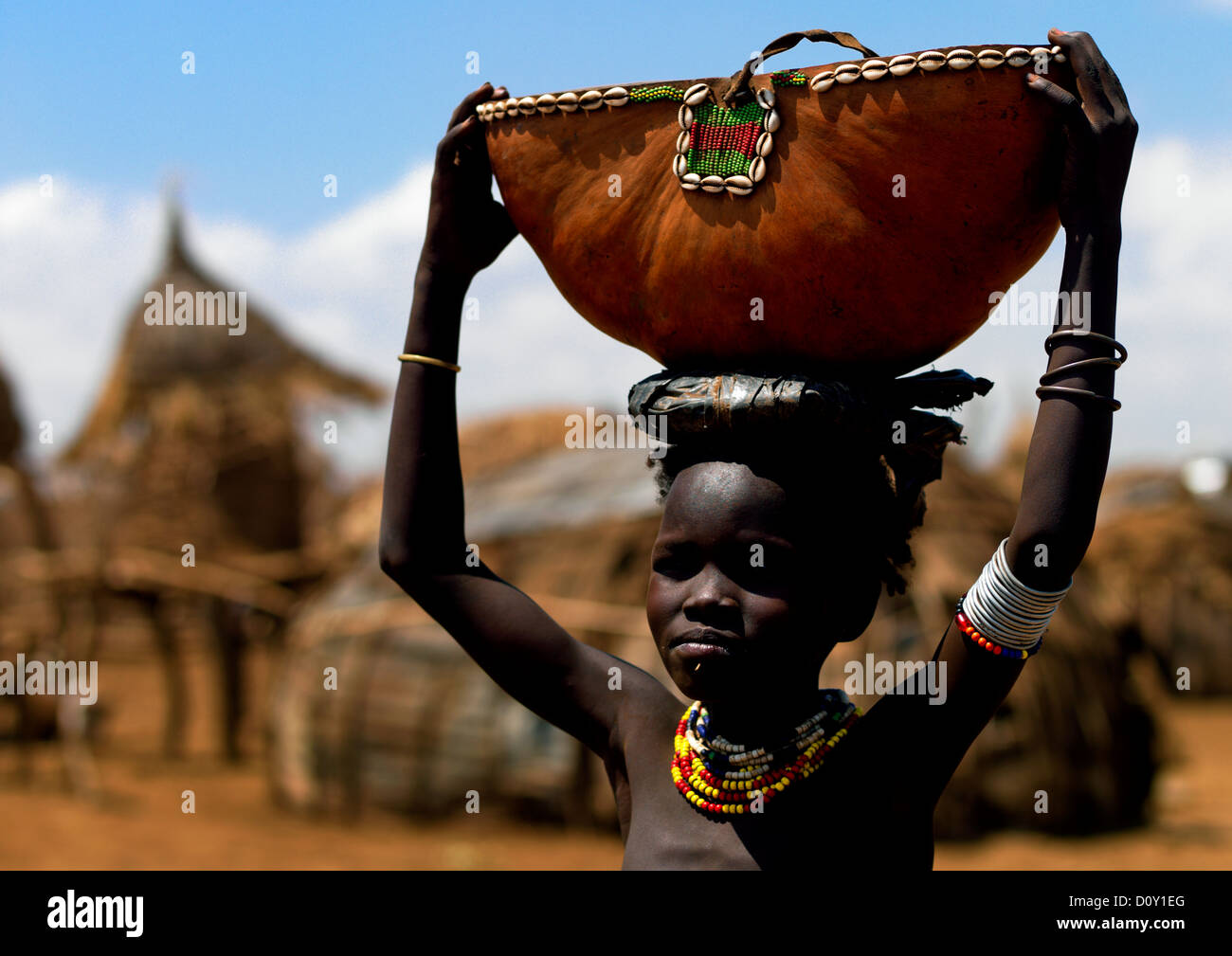 Portrait Of A Dassanech Tribe Girl Holding A Calabash On Her Head ...