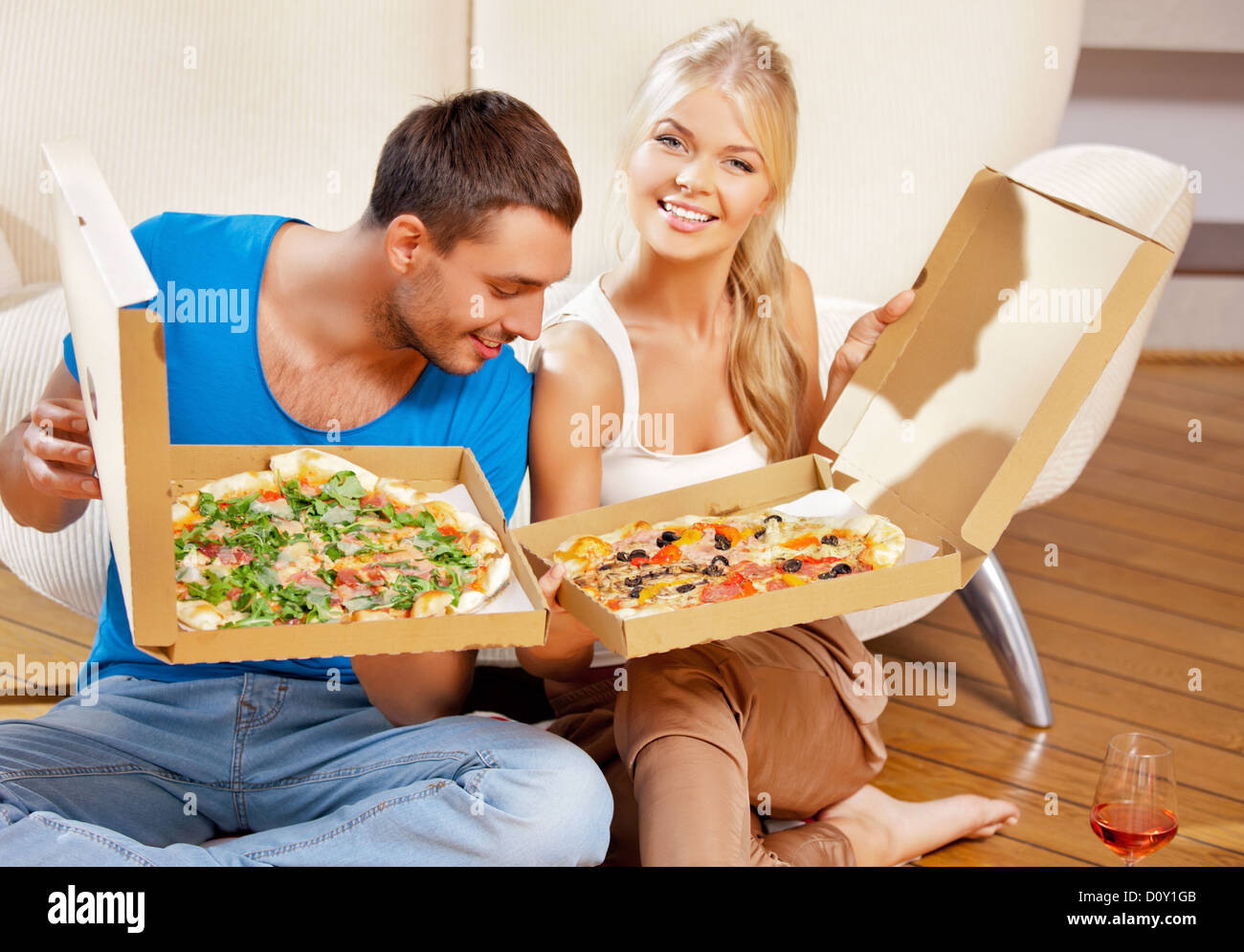 romantic couple eating pizza at home Stock Photo - Alamy