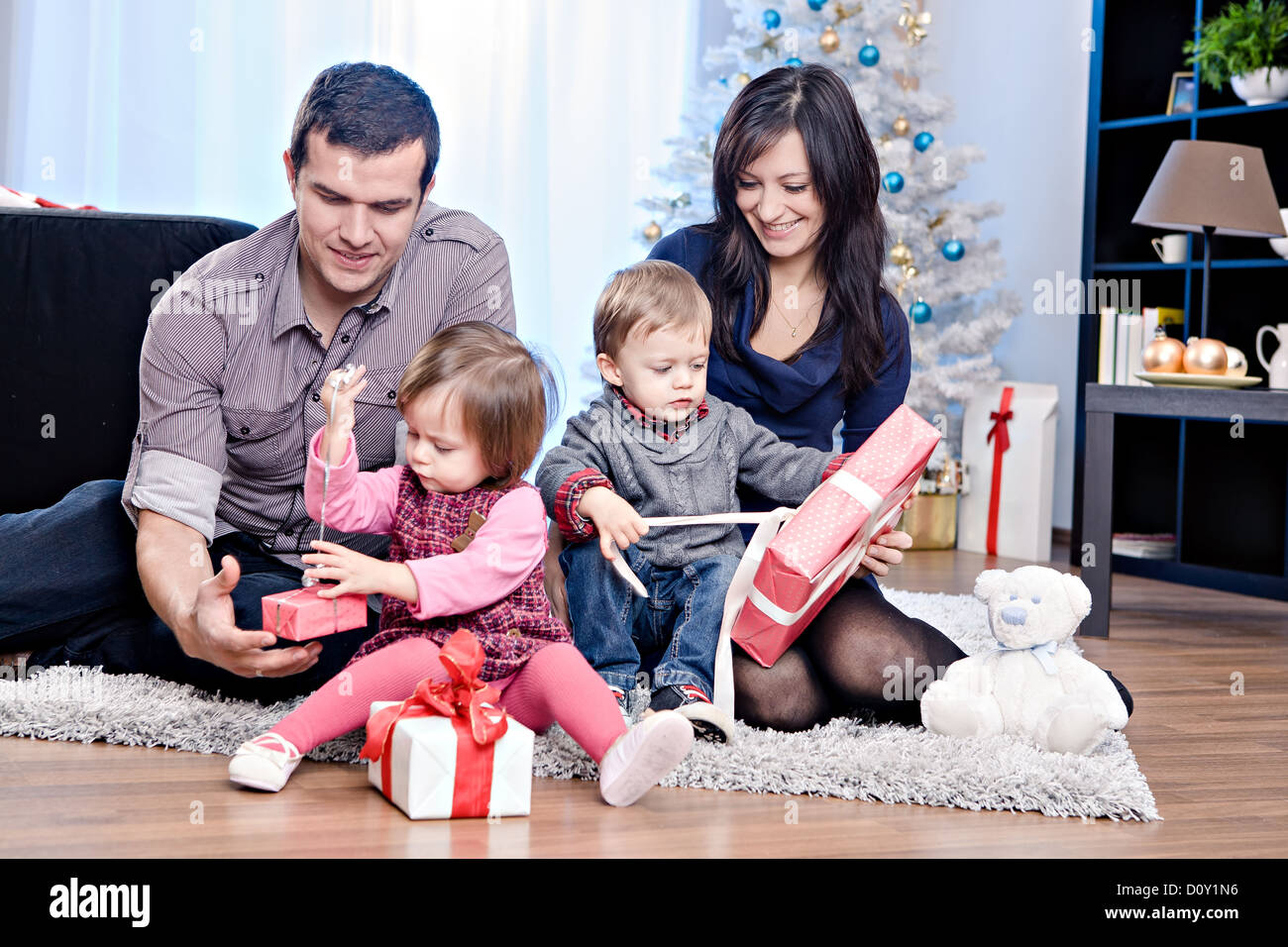 a young family getting Christmas gifts Stock Photo - Alamy