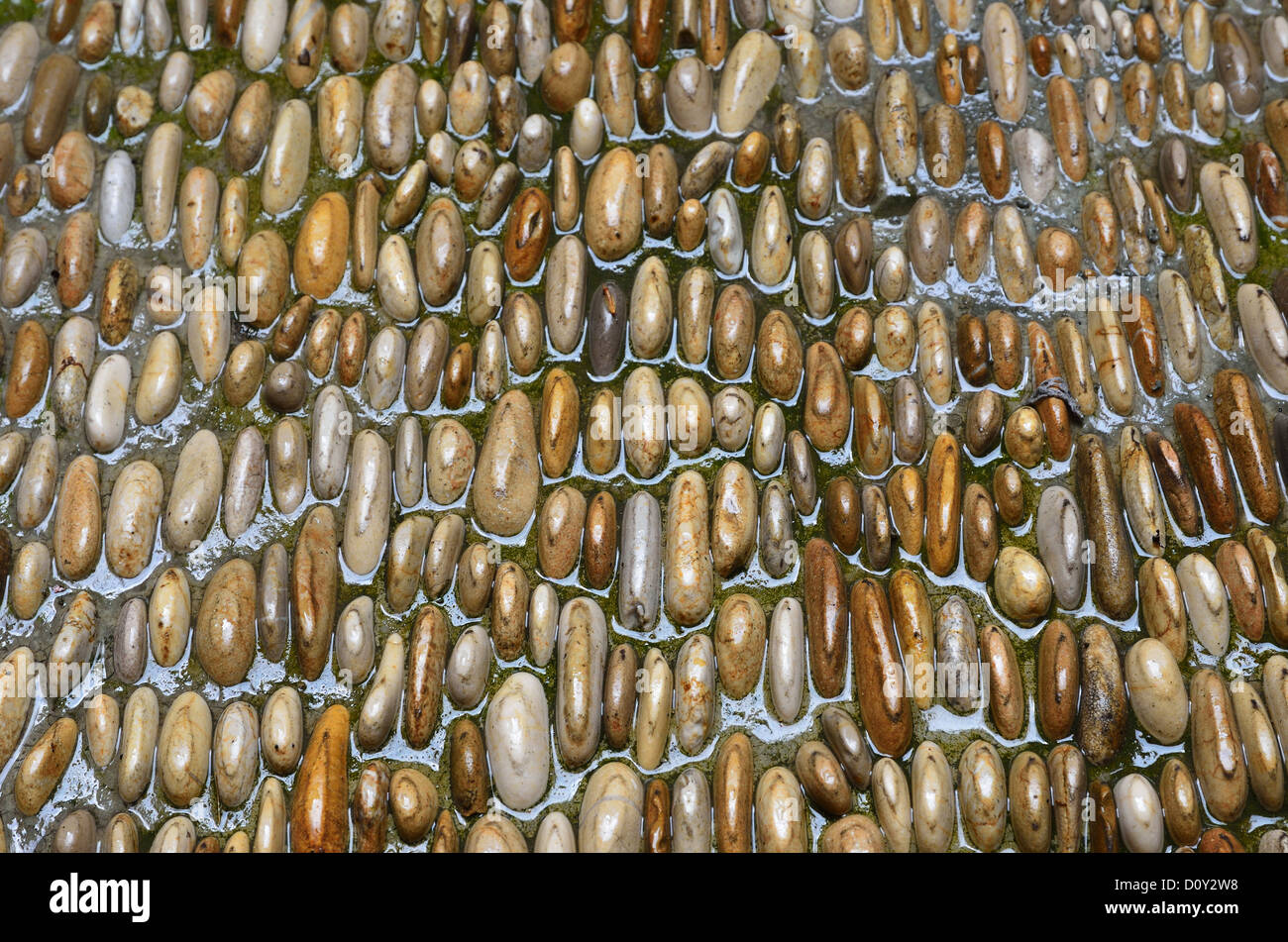 Pebble pavement flooded with water Stock Photo - Alamy