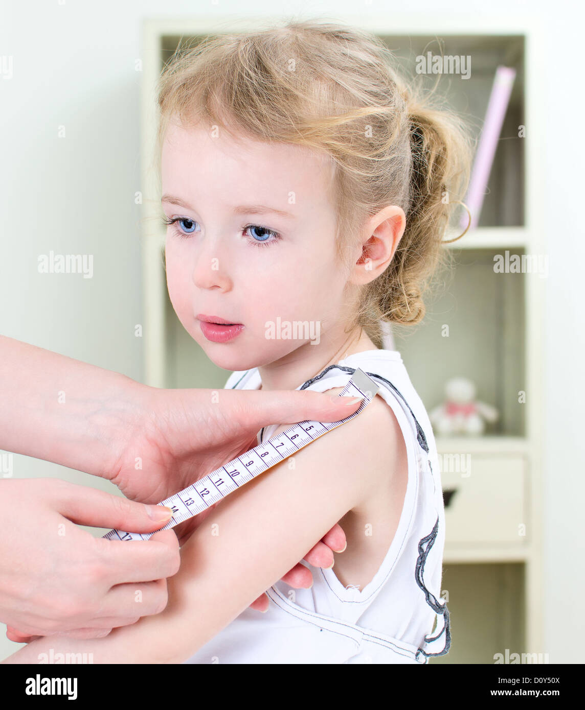 Pediatrician measuring toddler's forearm to monitor the development ...