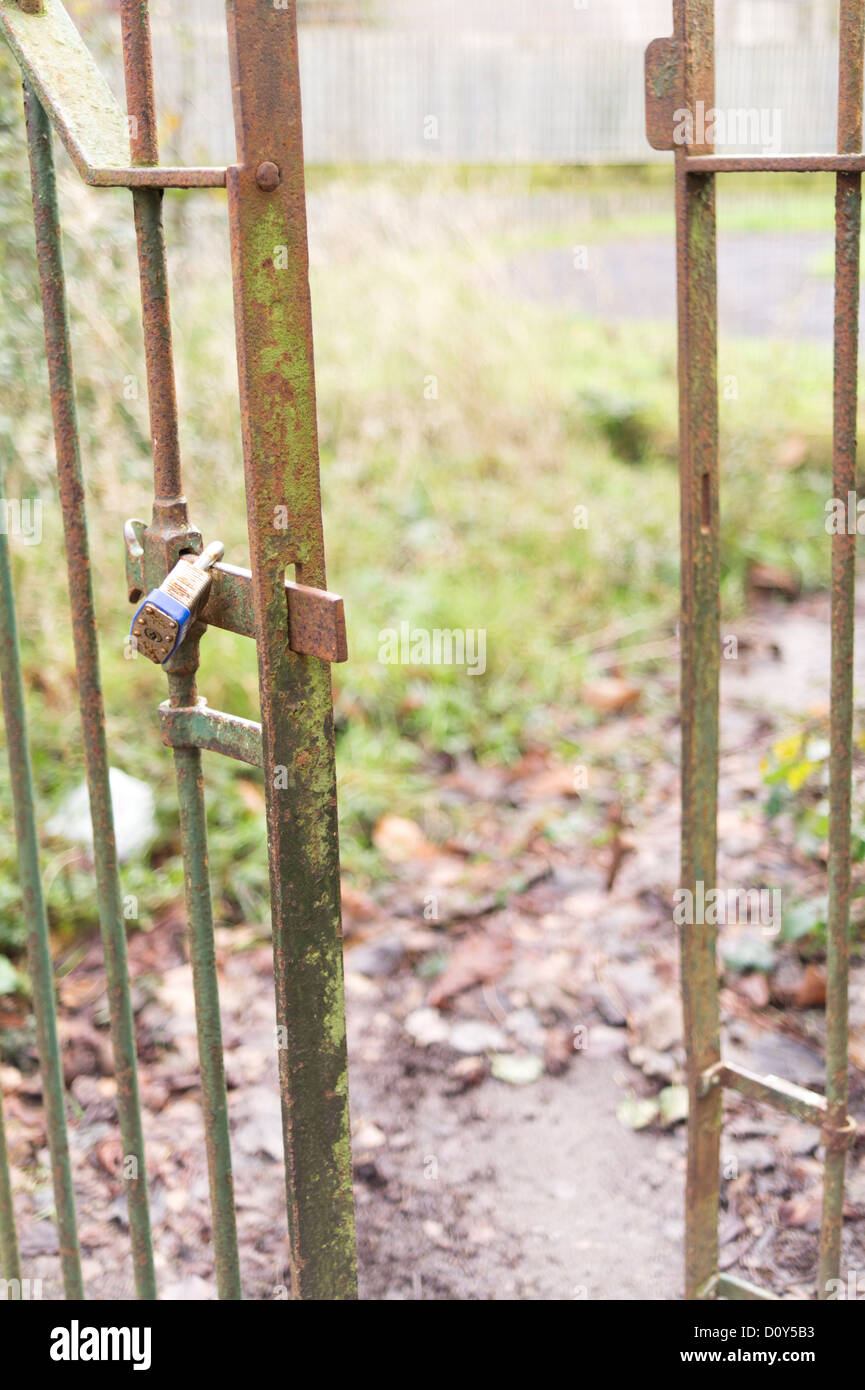 Rusty iron gate unlocked and open Stock Photo - Alamy