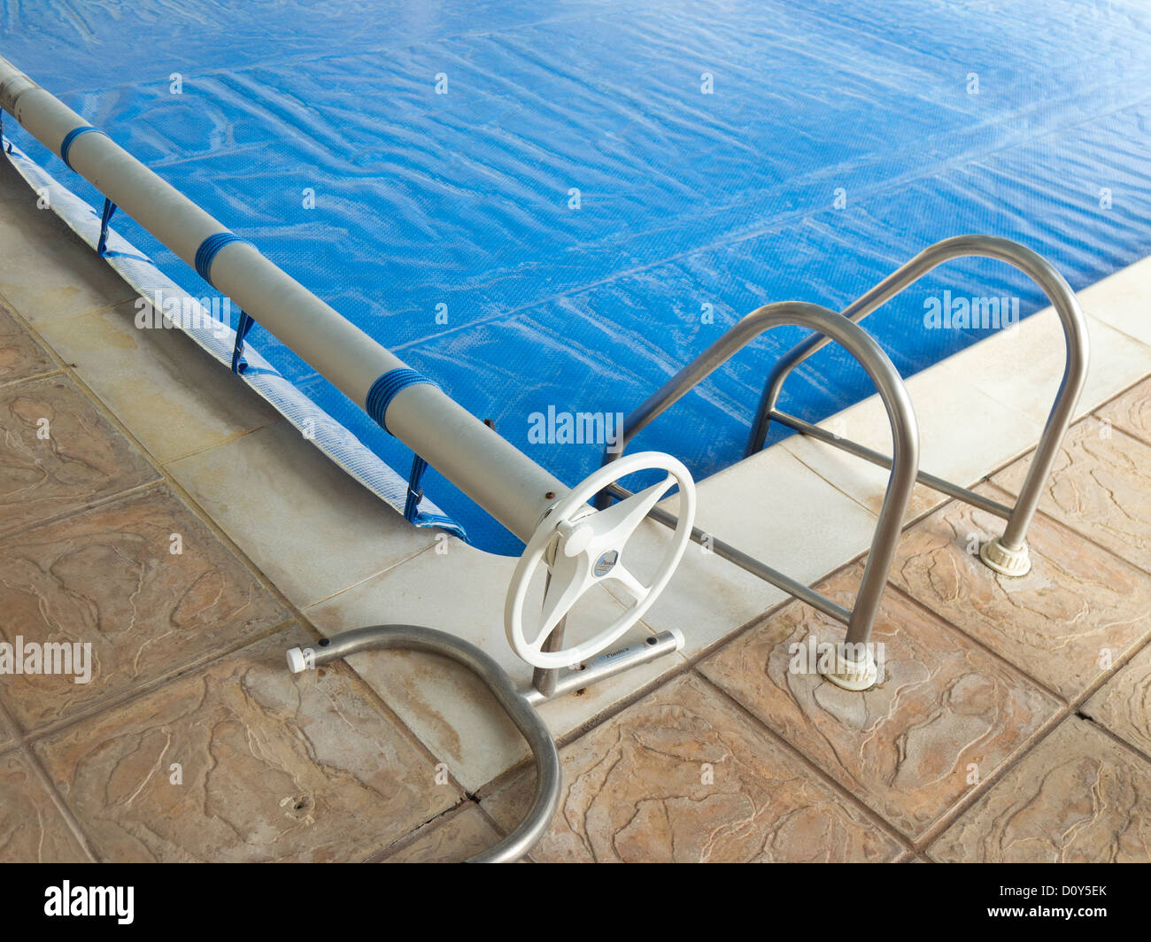 Swimming pool cover in place over water Stock Photo - Alamy