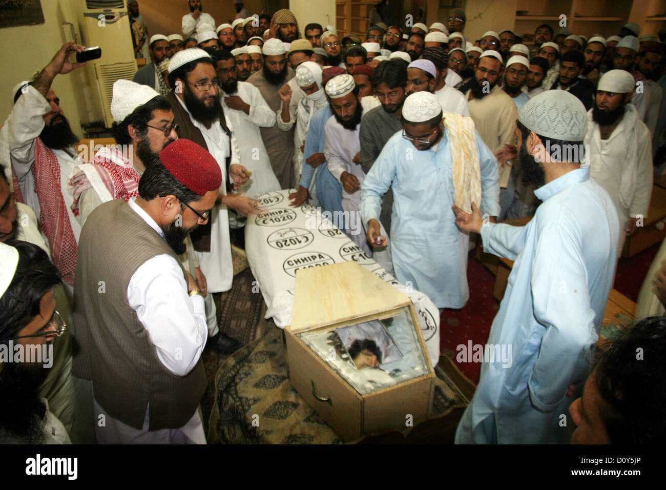 People watching dead body of religious scholar Muhammad Ismail last time before his funeral ...