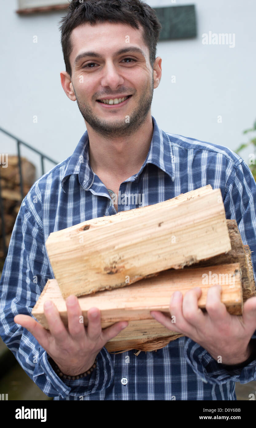 Young Man Carrying Chopped Wood Stock Photo - Alamy