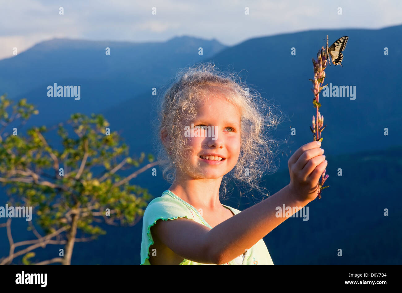 girl and butterfly in sunset mountain Stock Photo - Alamy