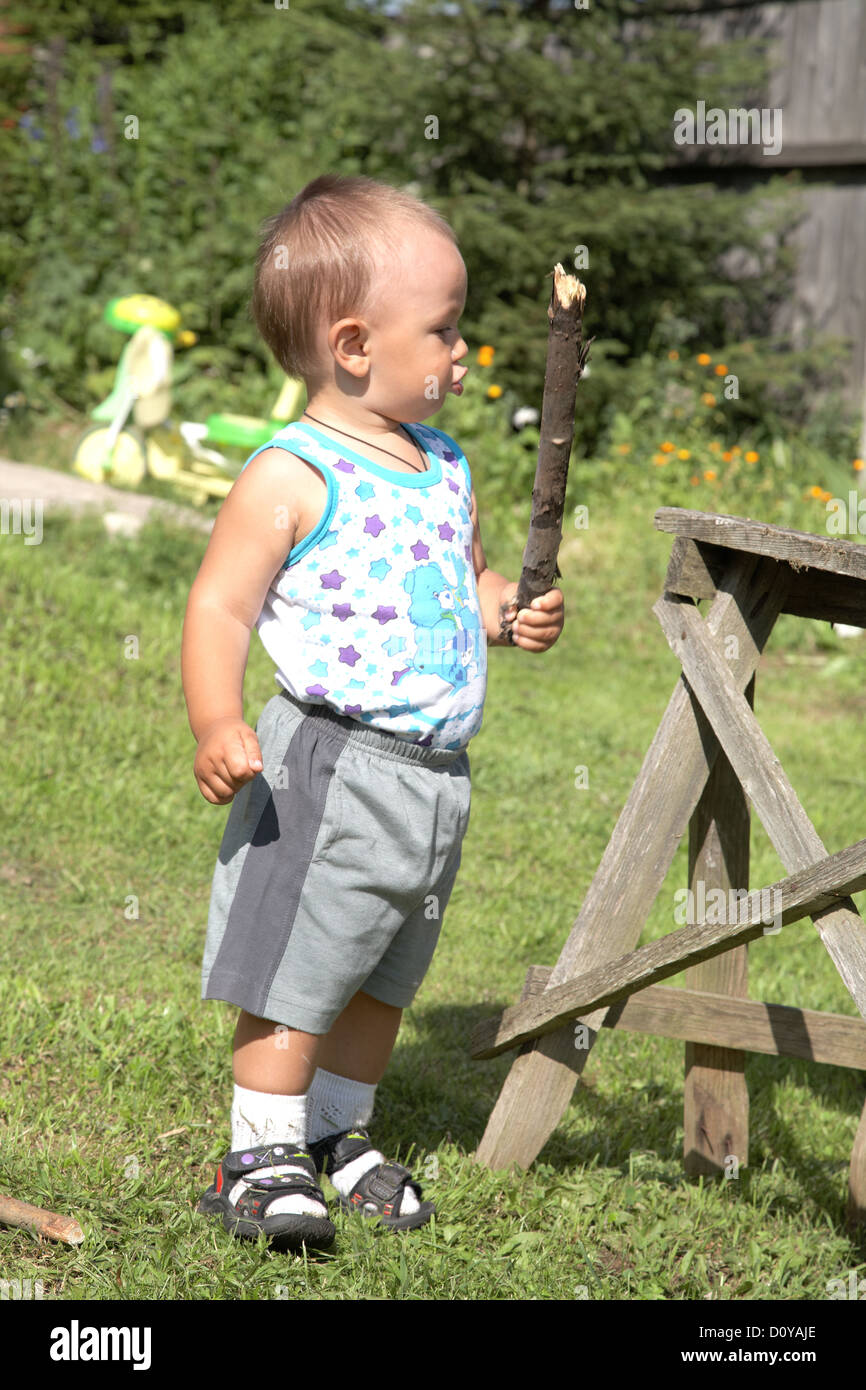 The little boy holds in hands a stick Stock Photo - Alamy