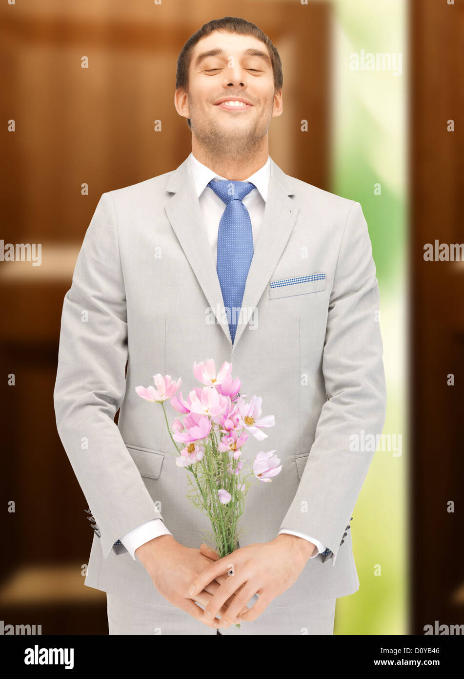 handsome man with flowers in hand Stock Photo - Alamy